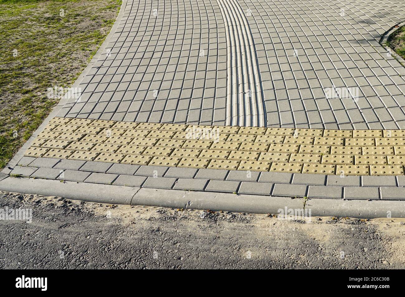 new paved walkway with guidelines for visually impaired people ...