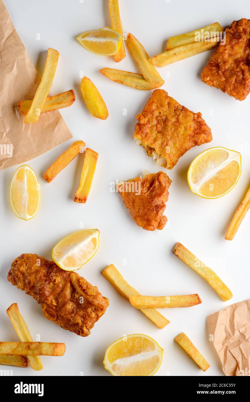 Fish and fries with lemon scattered on white background Stock Photo - Alamy