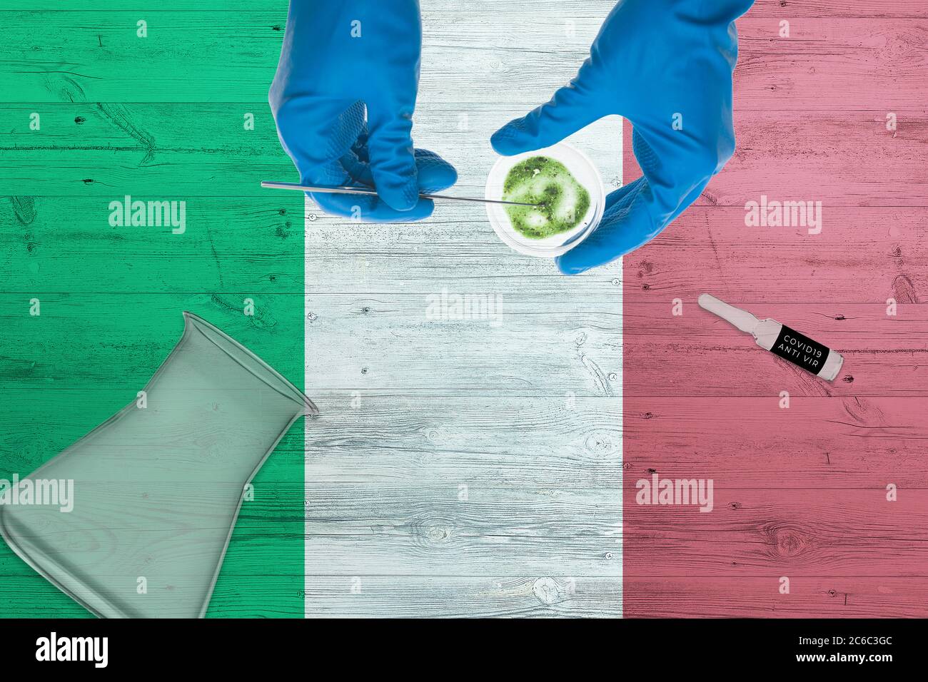 Italy flag on laboratory table. Medical healthcare technologist holding ...