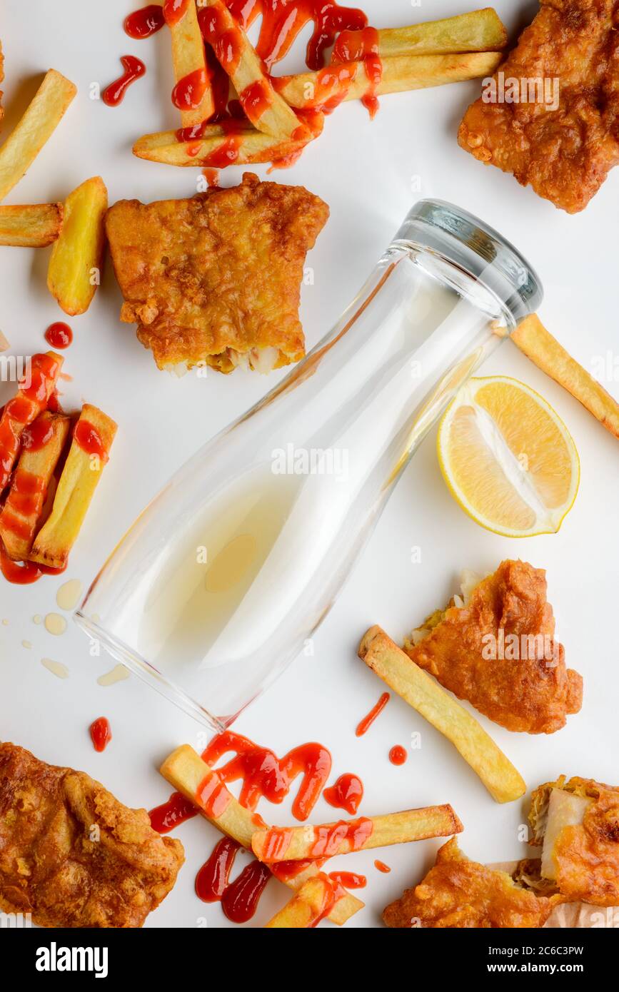 Fallen empty glass of beer among fish and chips Stock Photo - Alamy