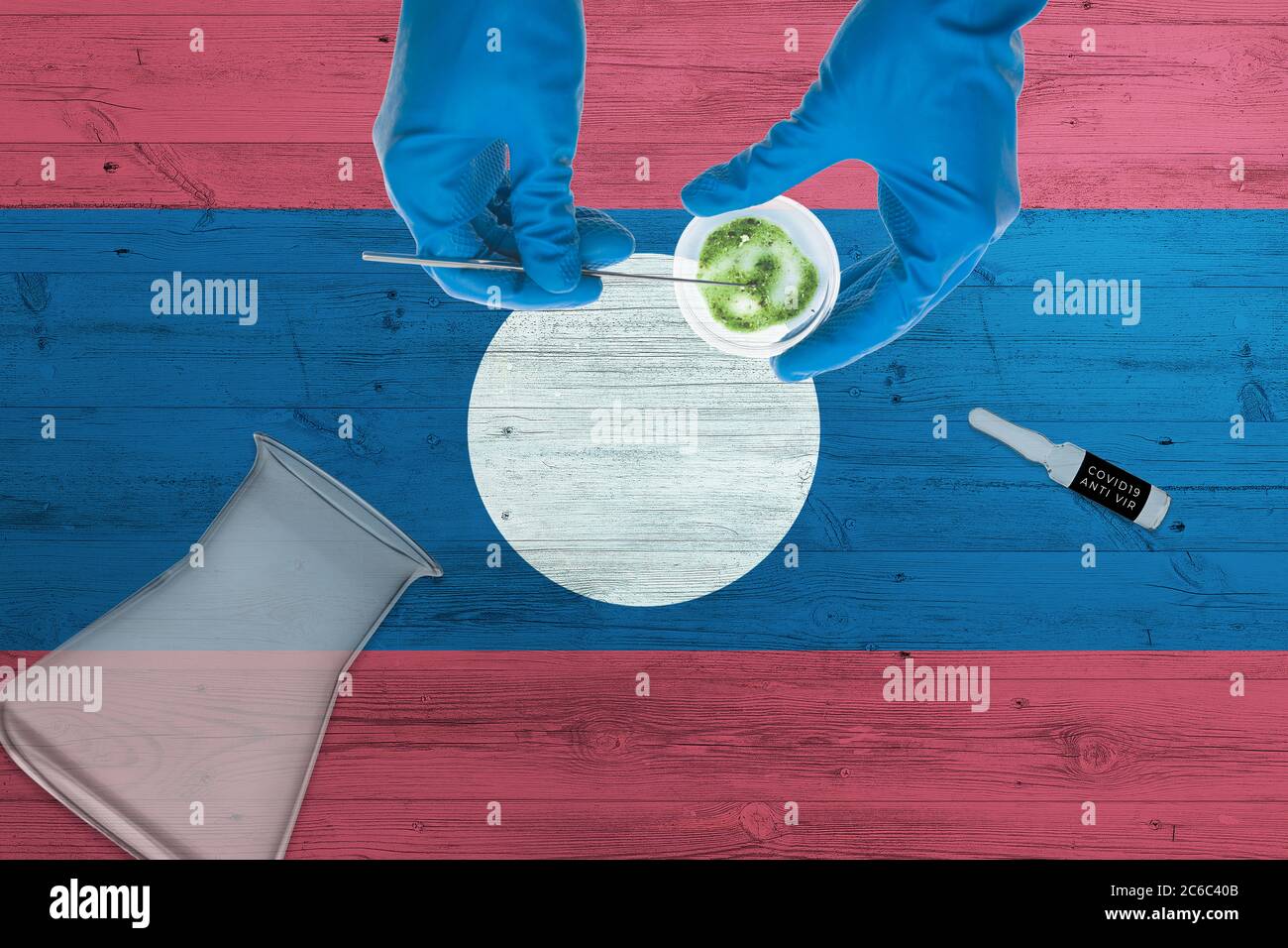 Laos flag on laboratory table. Medical healthcare technologist holding ...
