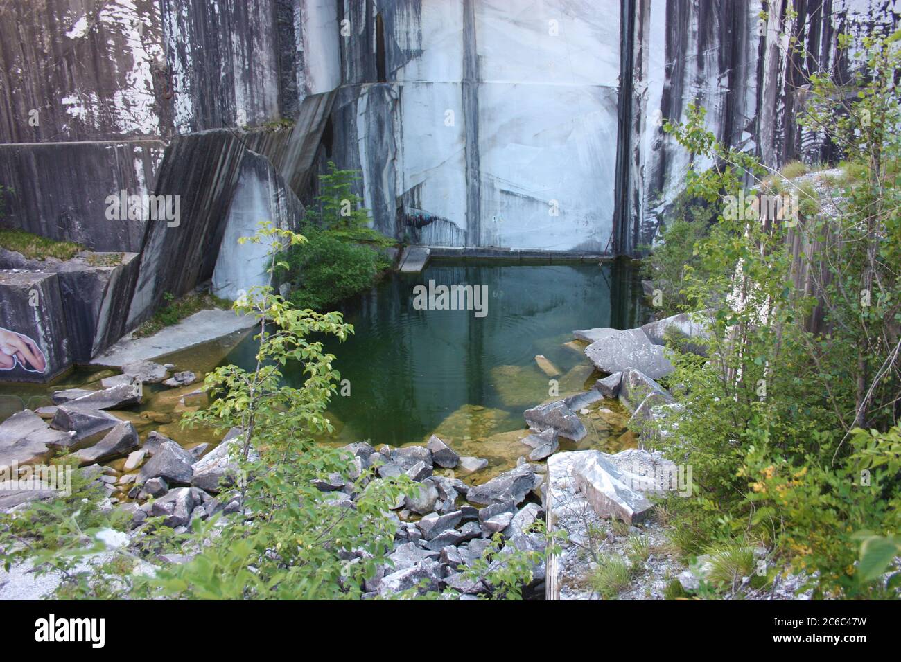 small natural lake inside a marble quarry in mountain in apuan alps ...