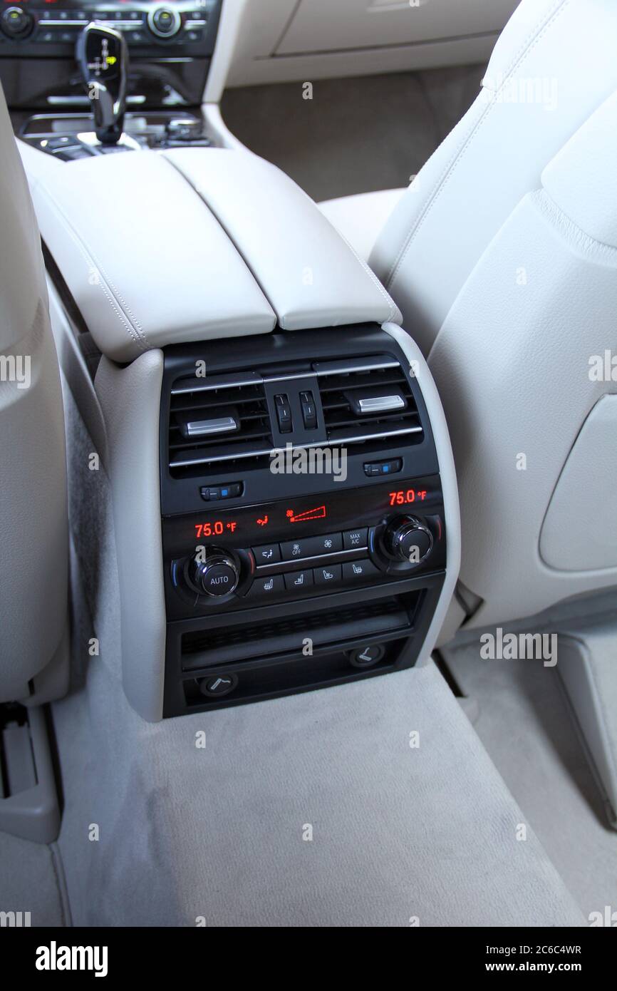 Air conditioning controls in the rear seat rear seat in a luxury car ...