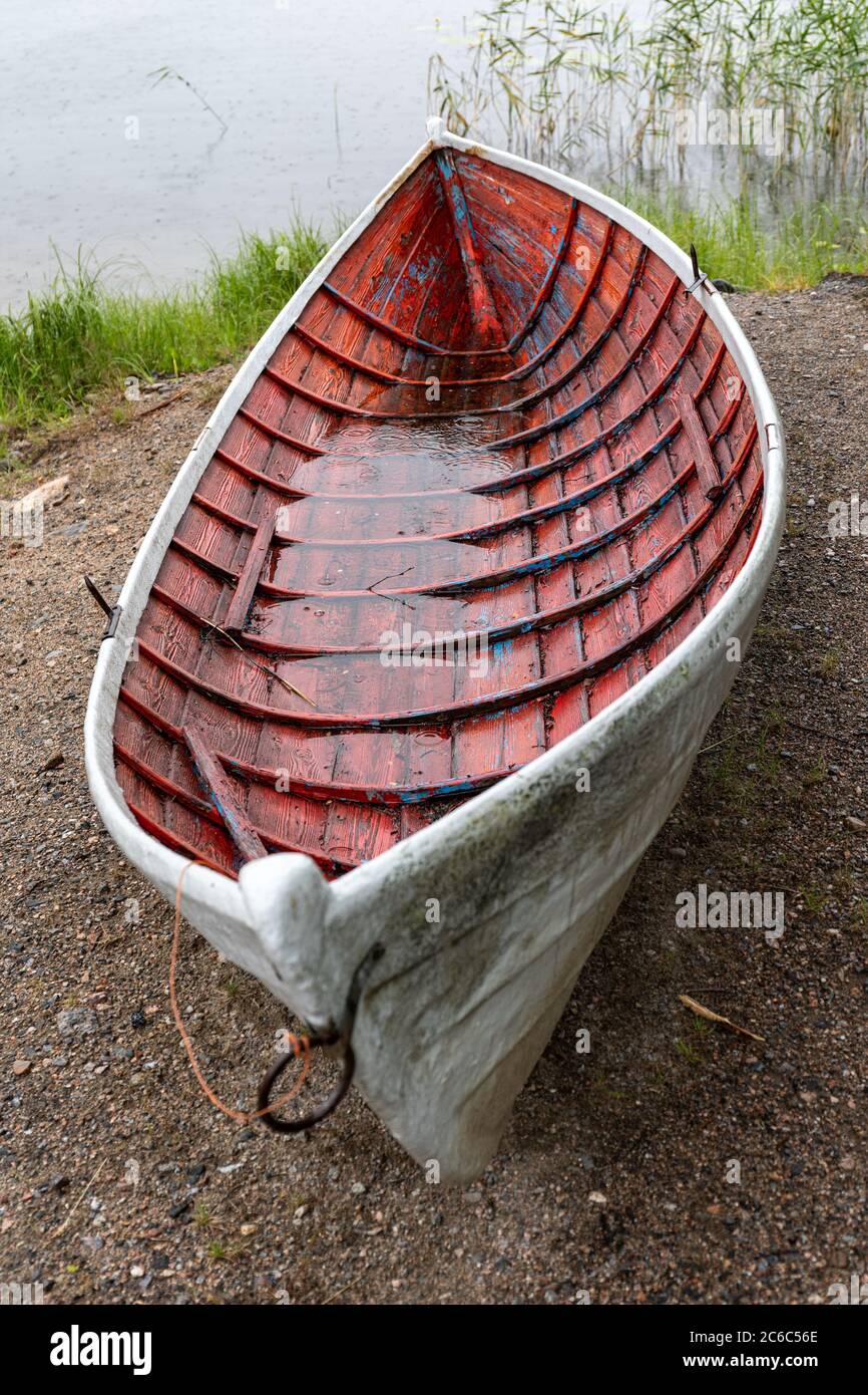 Old wooden rowboat with white glassfiber coating on a rainy day Stock ...