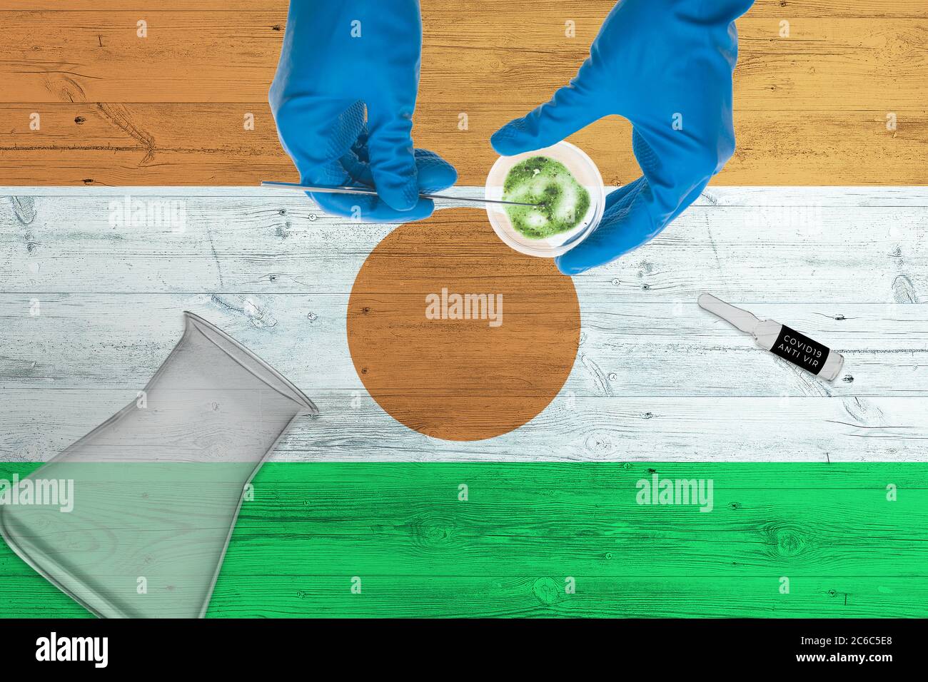 Niger flag on laboratory table. Medical healthcare technologist holding ...