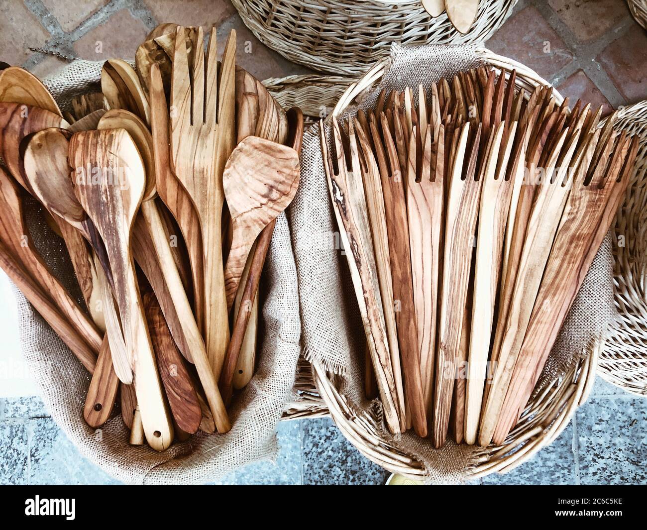 Traditional souvenir objects. Wooden spoons and forks, knitted basket ...