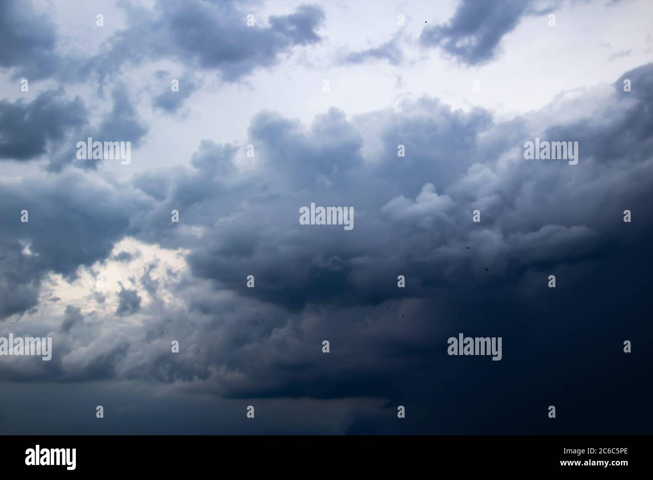 A beautiful stormy sky with clouds. The Dark heavy thunderstorm clouds ...