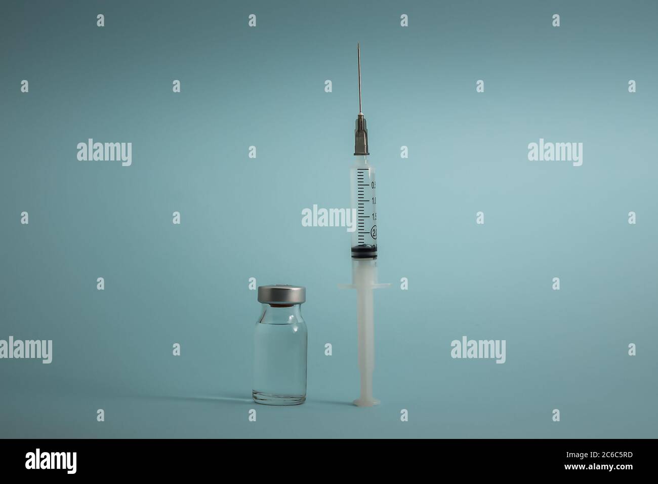 Small vaccine bottle (phial) and a medical syringe injection isolated ...