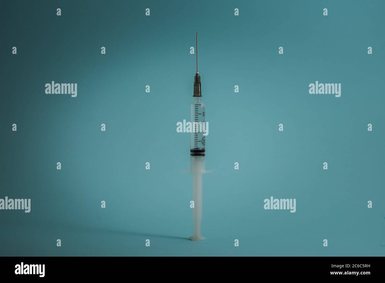 A medical syringe injection isolated on blue background Vaccination for ...
