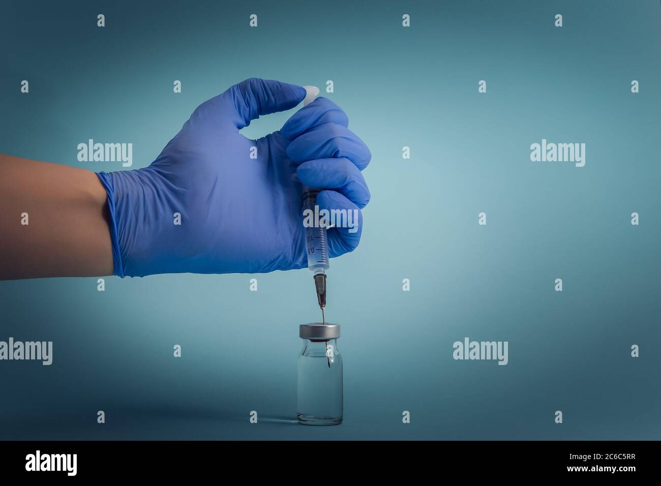 Small vaccine bottle (phial) and a medical syringe injection in a ...