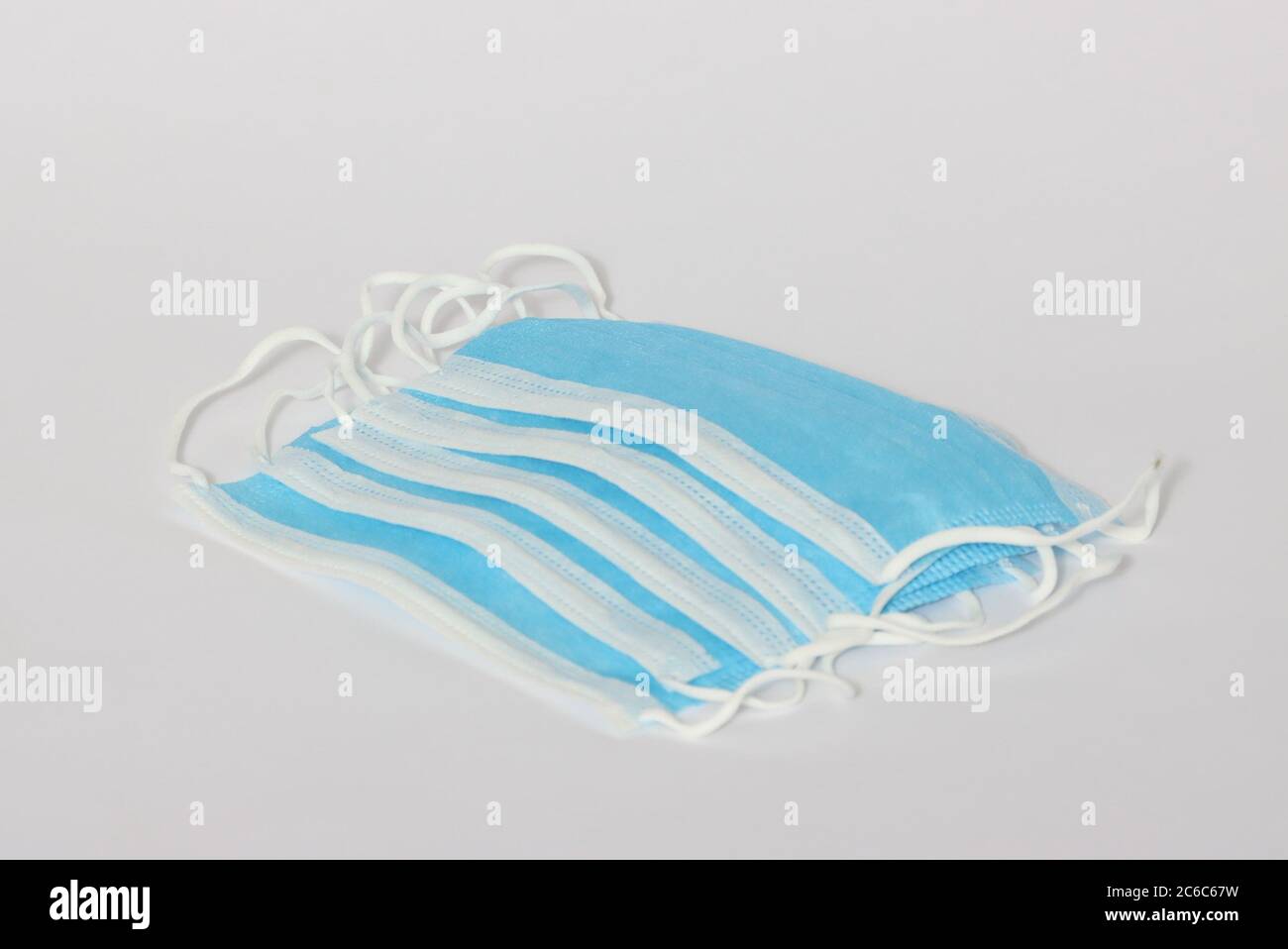 5, blue disposable masks on a white background Stock Photo - Alamy