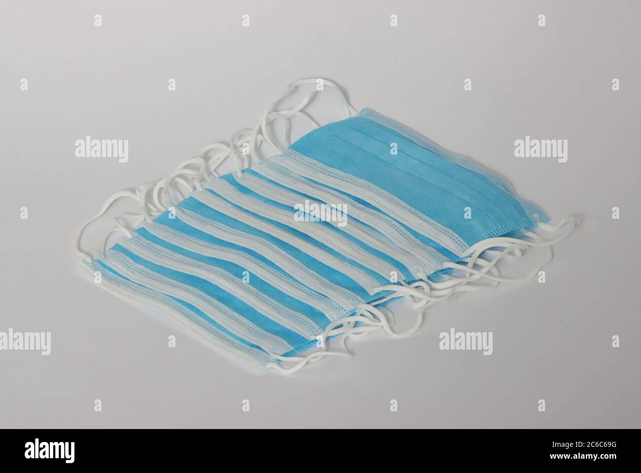 10, blue disposable masks on a white background Stock Photo - Alamy