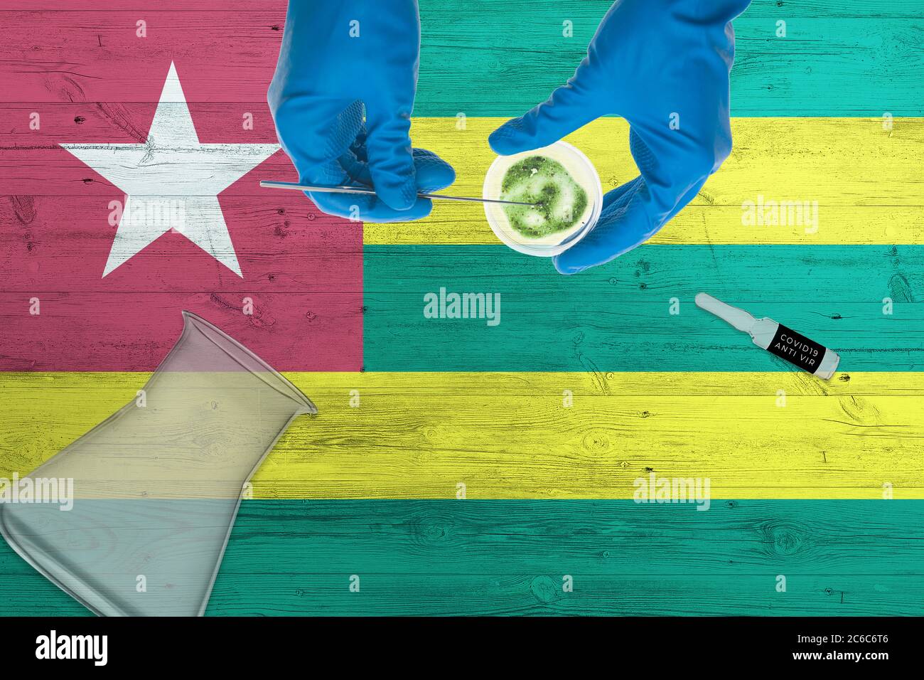 Togo flag on laboratory table. Medical healthcare technologist holding ...