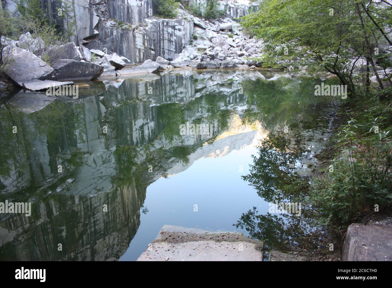 small natural lake inside a marble quarry in mountain in apuan alps ...
