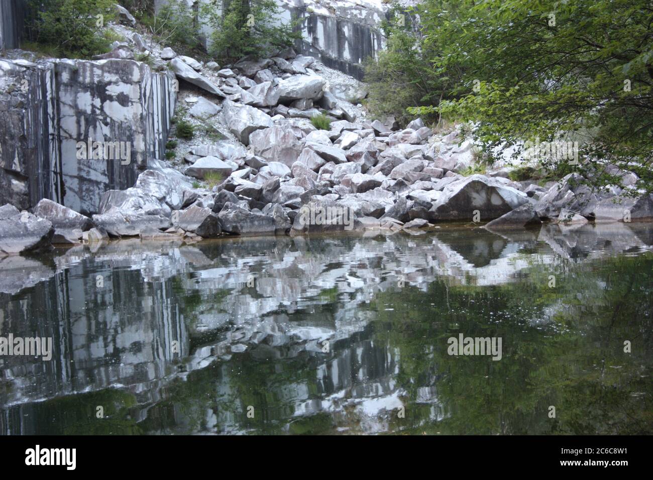 small natural lake inside a marble quarry in mountain in apuan alps ...