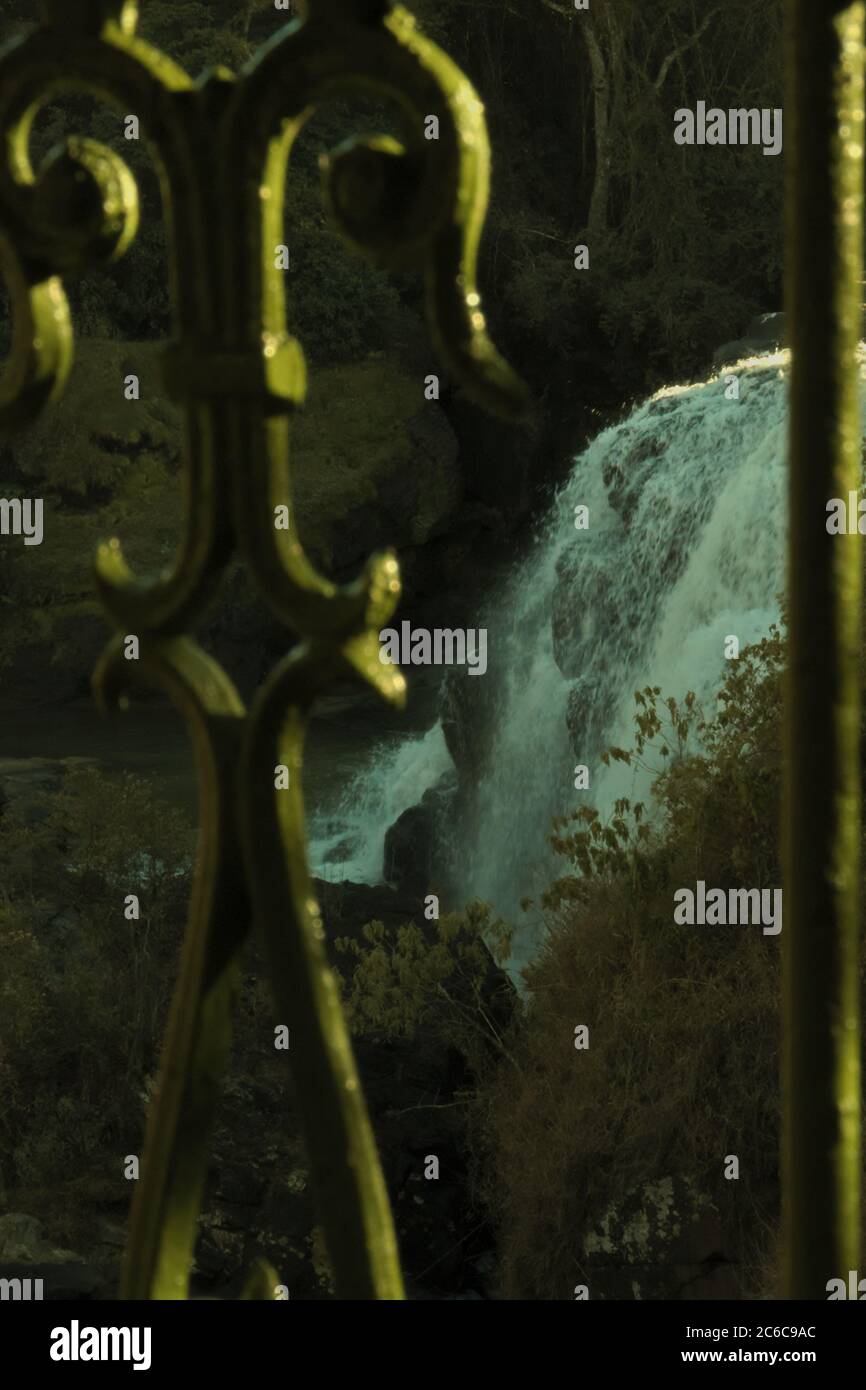Waterfall framed by the adornments of a railing Stock Photo - Alamy