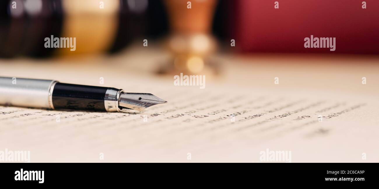 Law, notary background theme. Fountain pen and handmade paper on desk ...