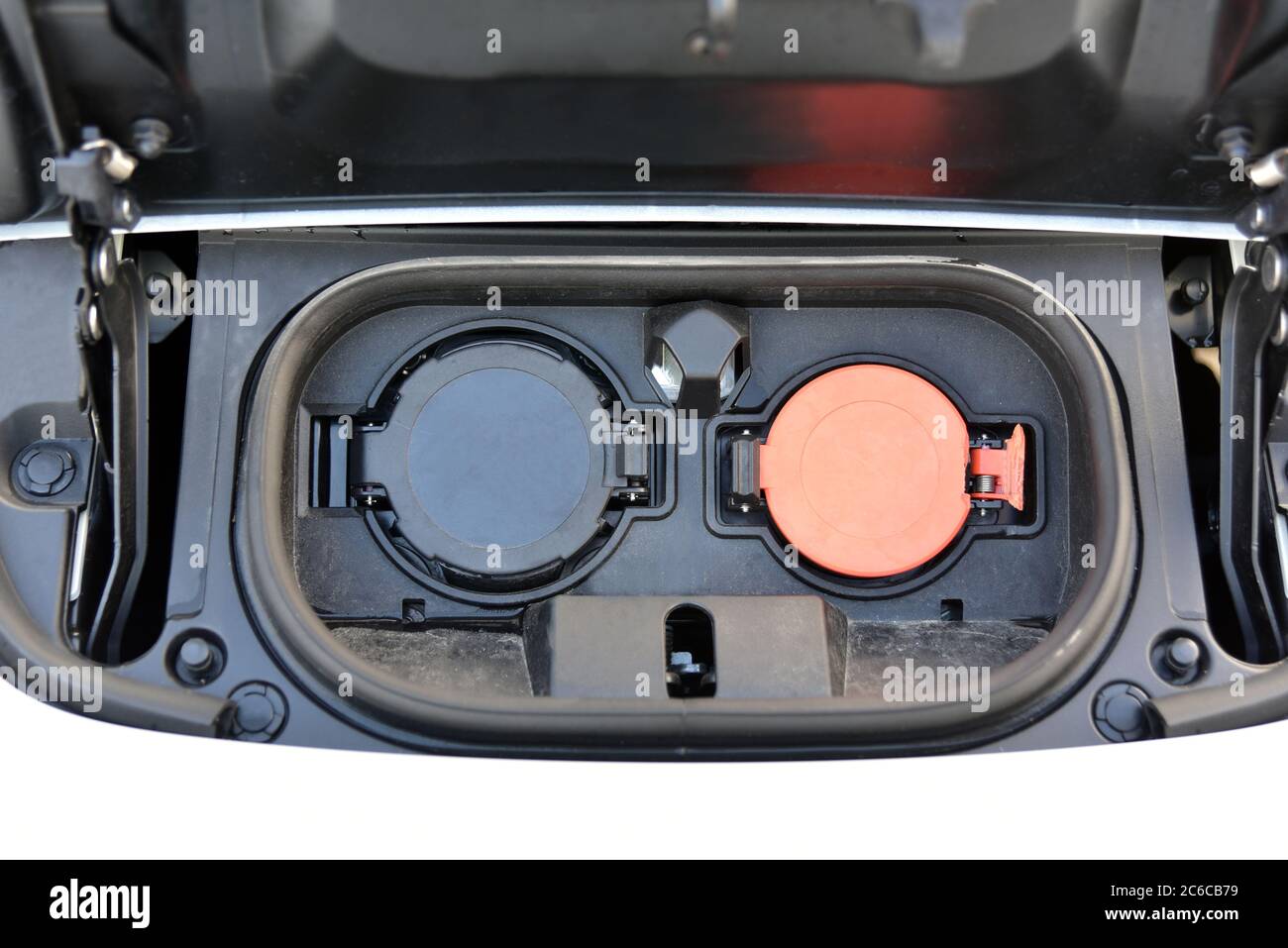 Electric vehicle charging socket by protective cover Stock Photo - Alamy