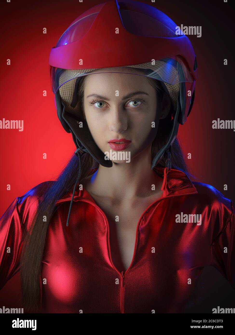 Girl in a red overalls and a red helmet. Portrait Stock Photo - Alamy