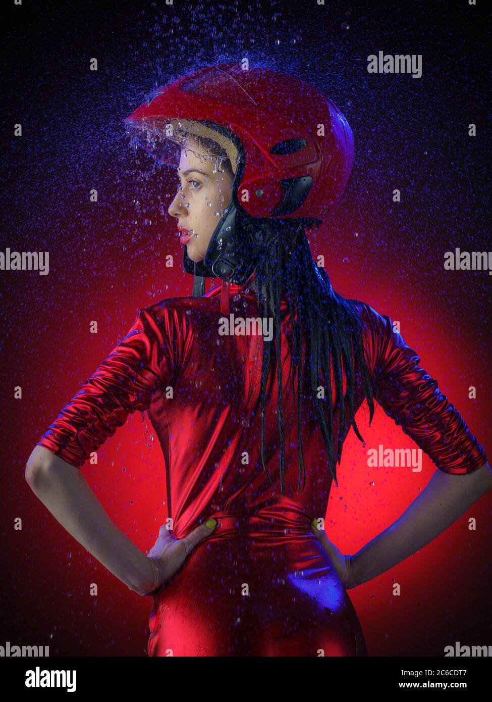 Girl in a red overalls and a red helmet. Water. In the studio, an ...