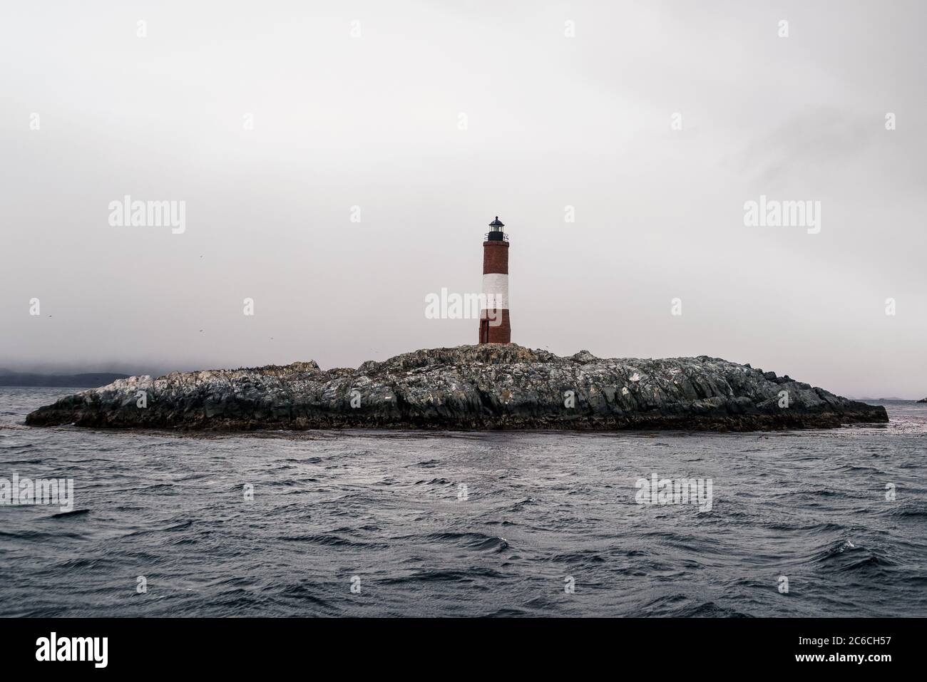 Lighthouse on an island in the middle of the sea Stock Photo - Alamy