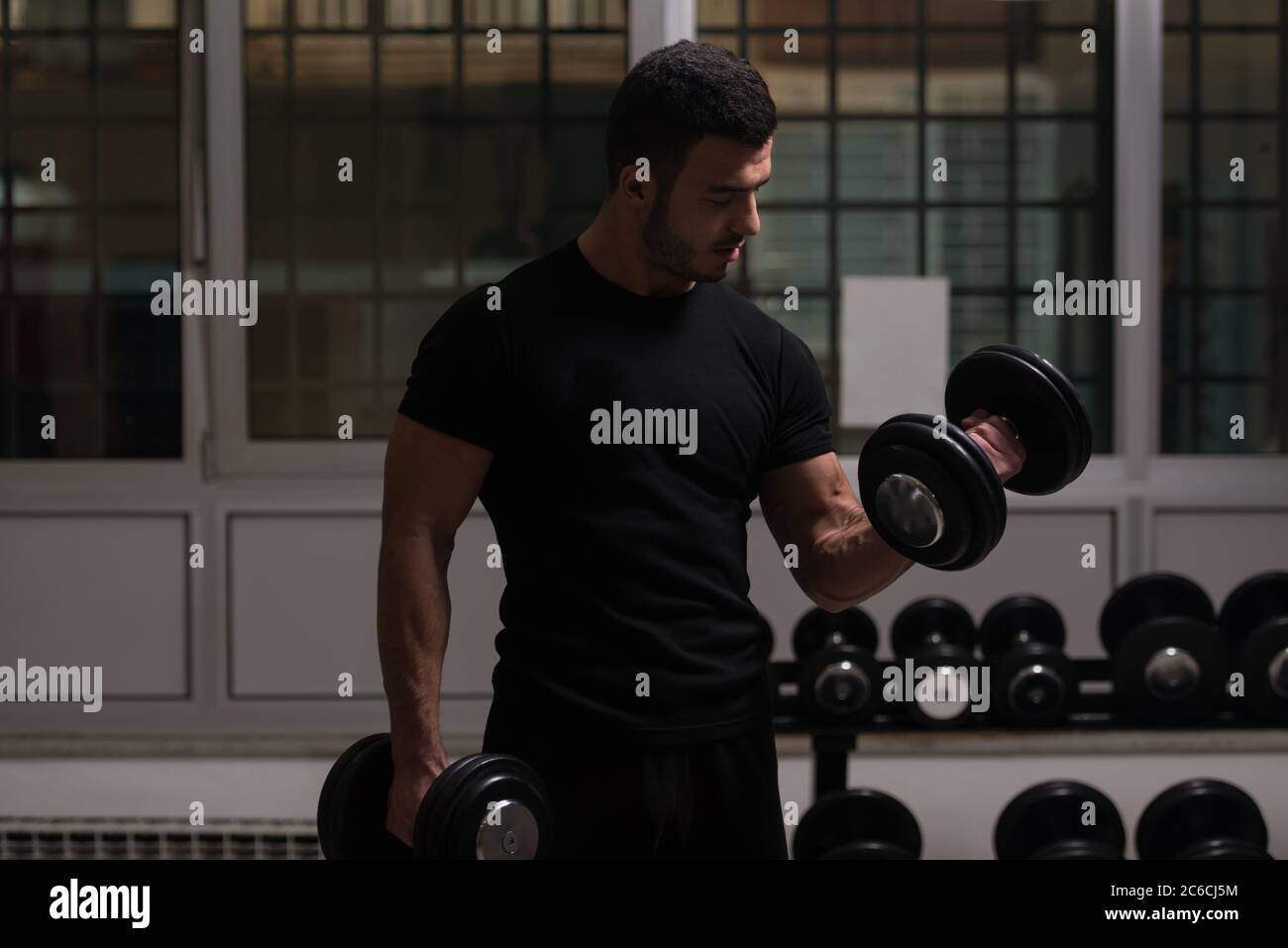 Athlete Working Out Biceps In A Gym - Dumbbell Concentration Curls ...