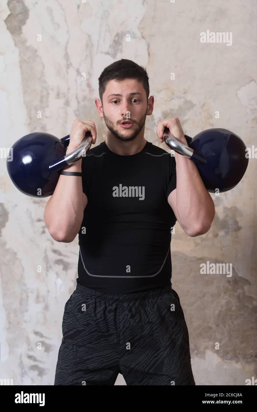 Man Exercising With Kettle Bell And Flexing Muscles - Muscular Athletic ...