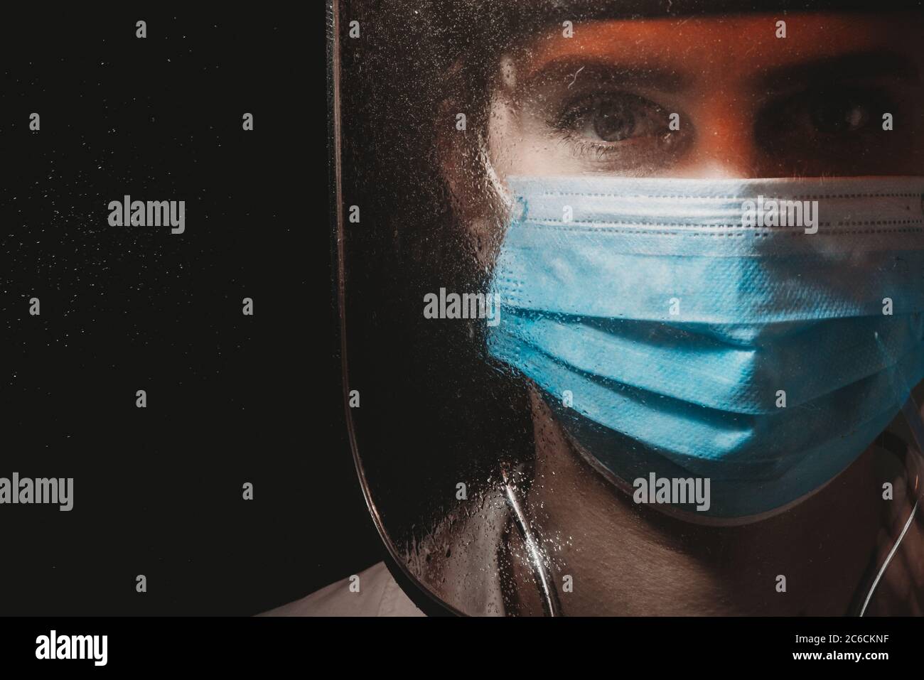 female doctor with mask and shield on black background Stock Photo - Alamy