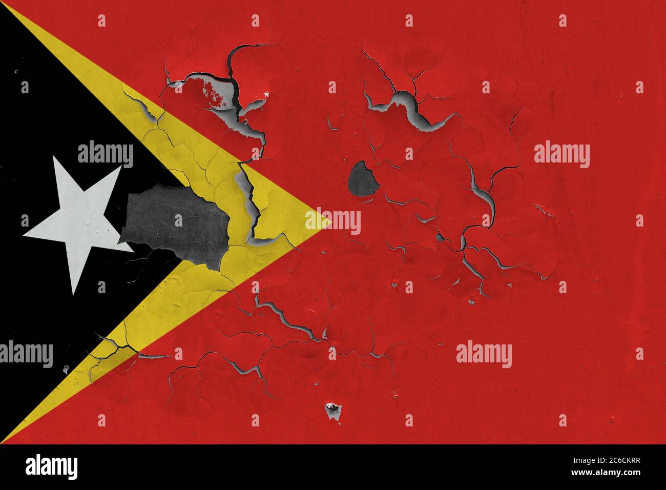 East Timor flag close up old, damaged and dirty on wall peeling off ...