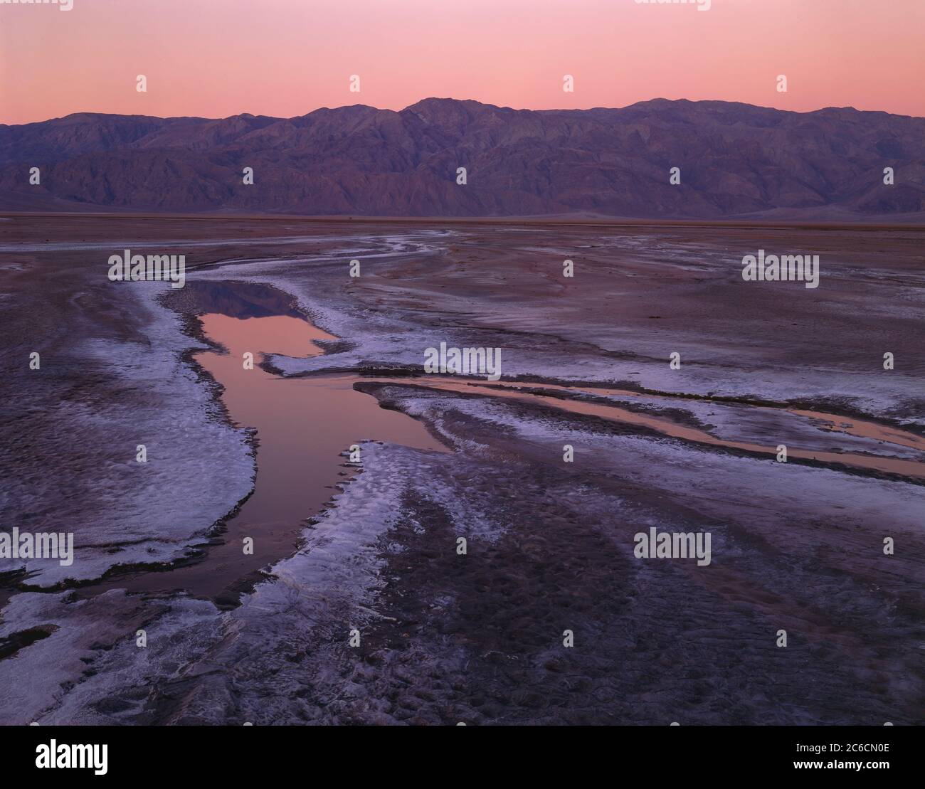 Death Valley National Monument CA / OCT A pink dawn sky reflects on the ...