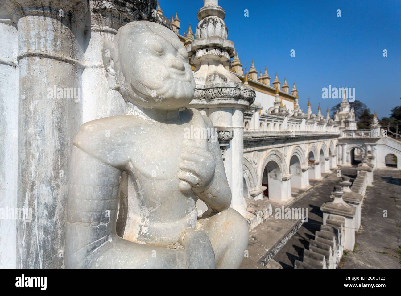 A close-up view of a carved stone statue at the exterior of an ancient ...
