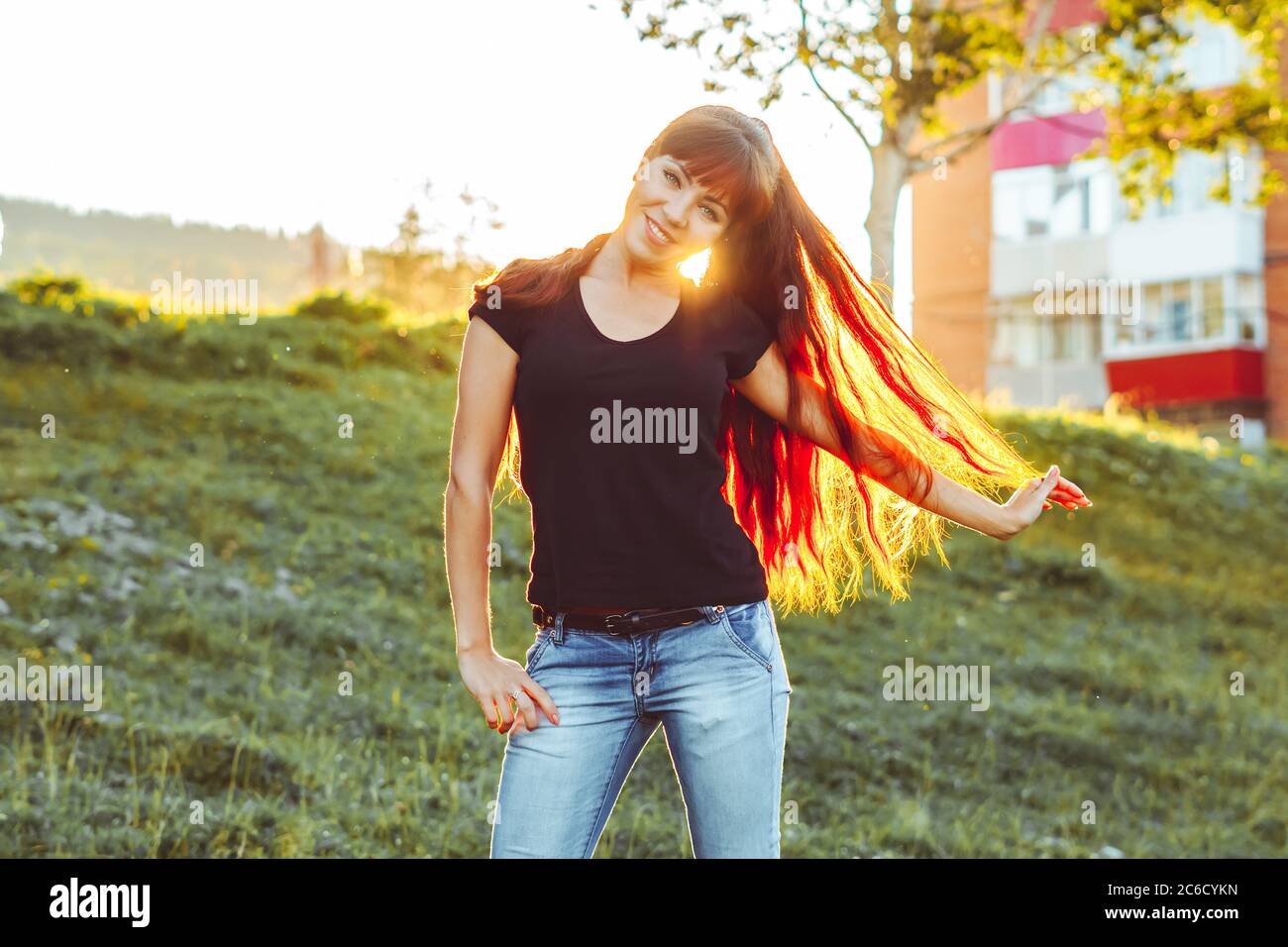 beautiful girl at sunset with long red hair in the sun Stock Photo - Alamy