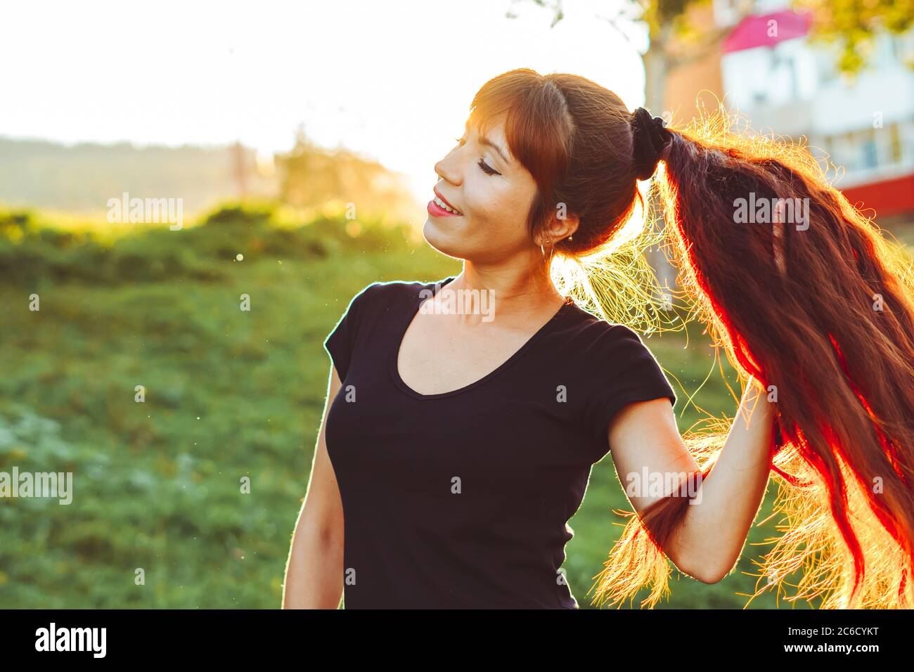 beautiful girl at sunset with long red hair in the sun Stock Photo - Alamy