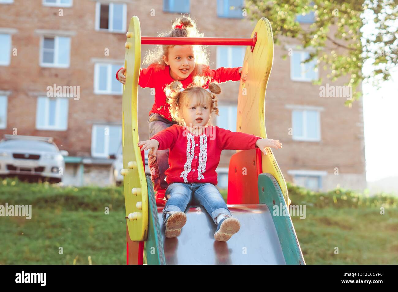 children play on the slide on a summer day bright sun Stock Photo - Alamy