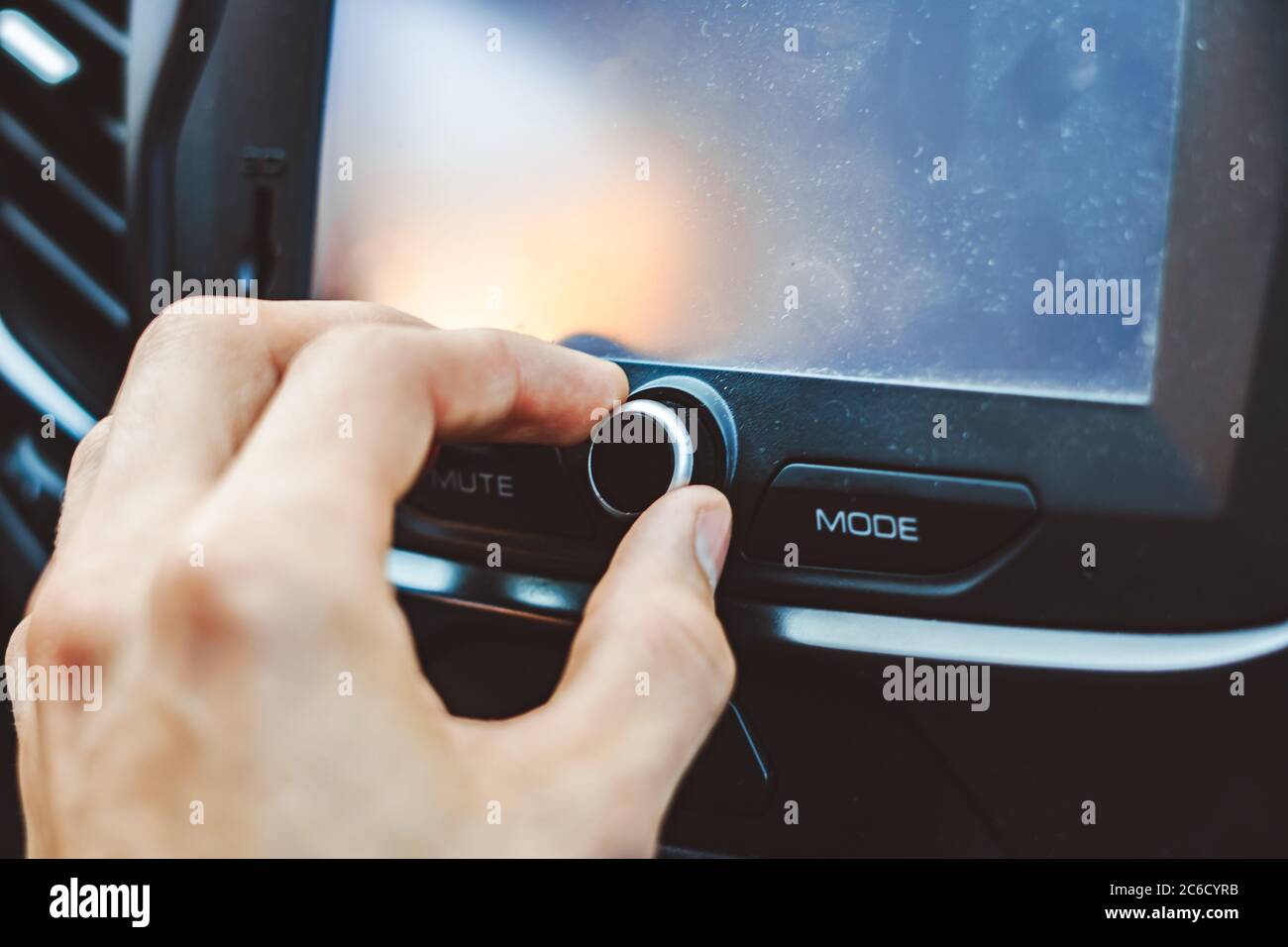 hand on the controller in the car interior on the control panel Stock ...