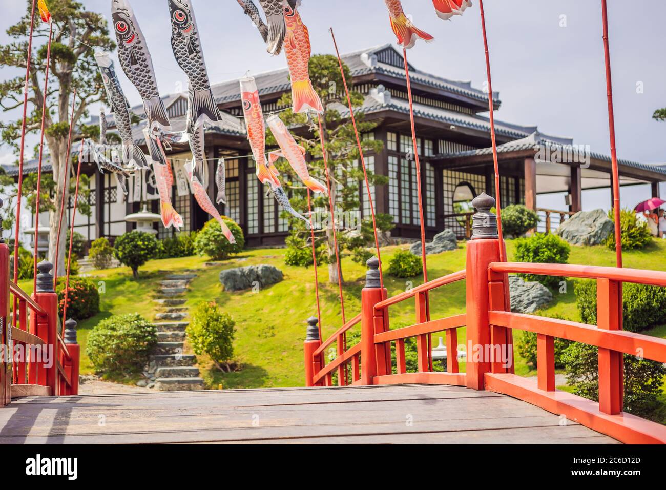 A red bridge over water in a Japanese garden Stock Photo - Alamy