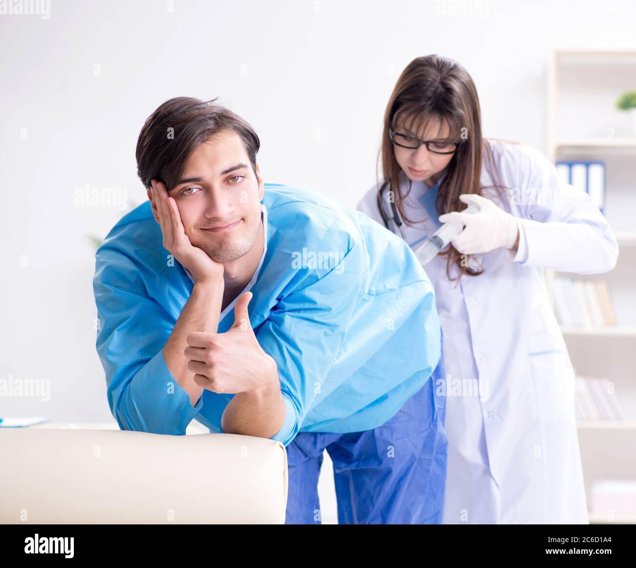 The funny man getting ready for buttocks syringe shot Stock Photo - Alamy