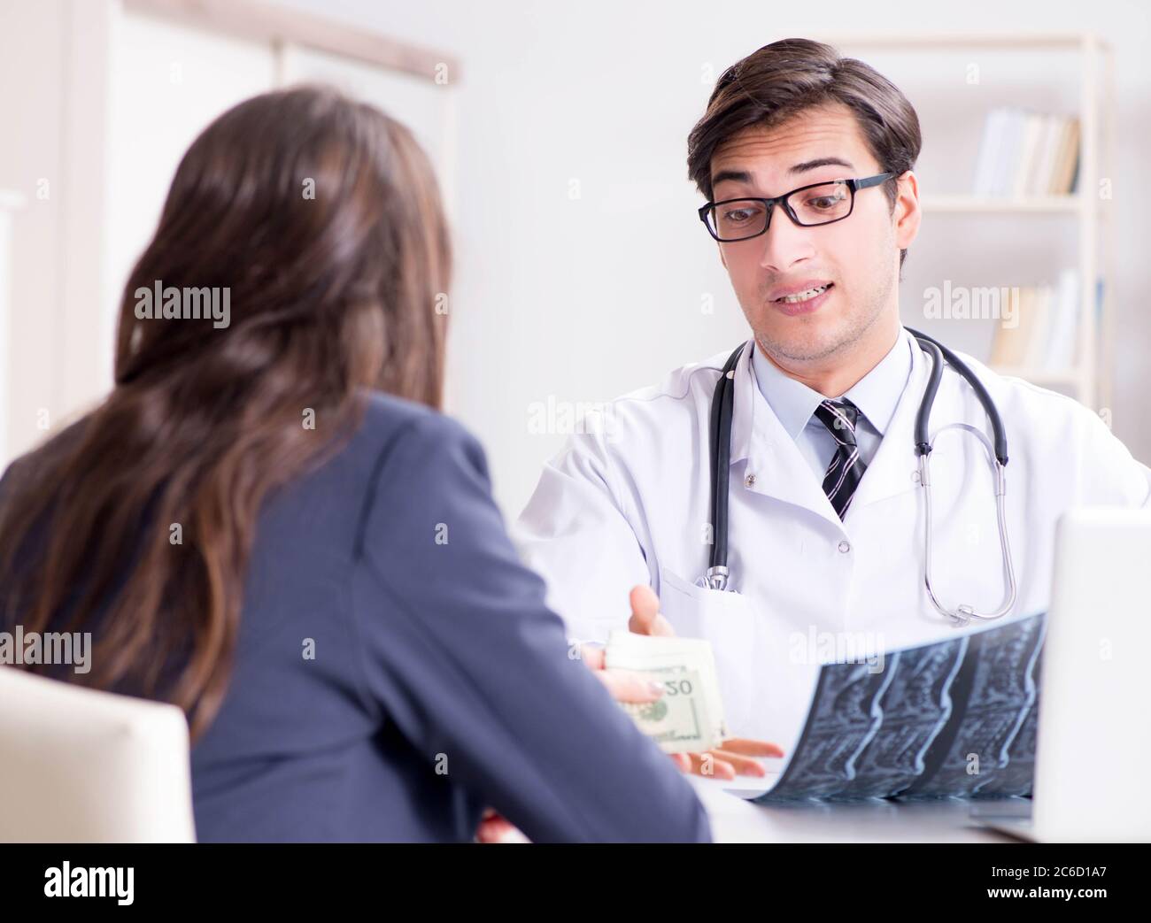 The doctor in corruption concept with being offered bribe Stock Photo ...