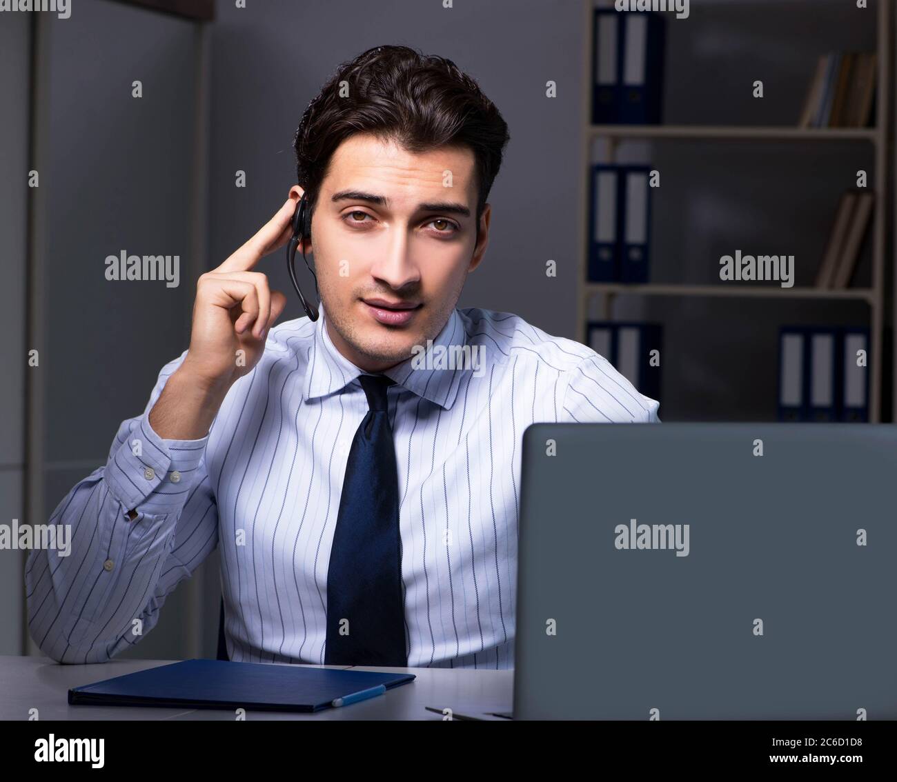 The call center operator talking to customer during night shift Stock ...