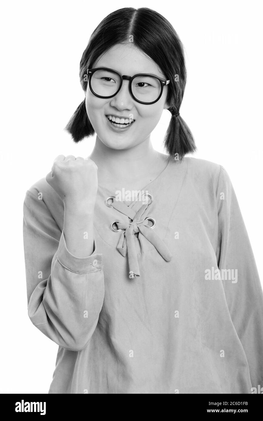 Thoughtful young happy Asian woman smiling while looking motivated ...