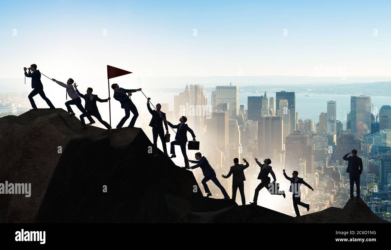 Concept of teamwork with team climbing mountain Stock Photo - Alamy