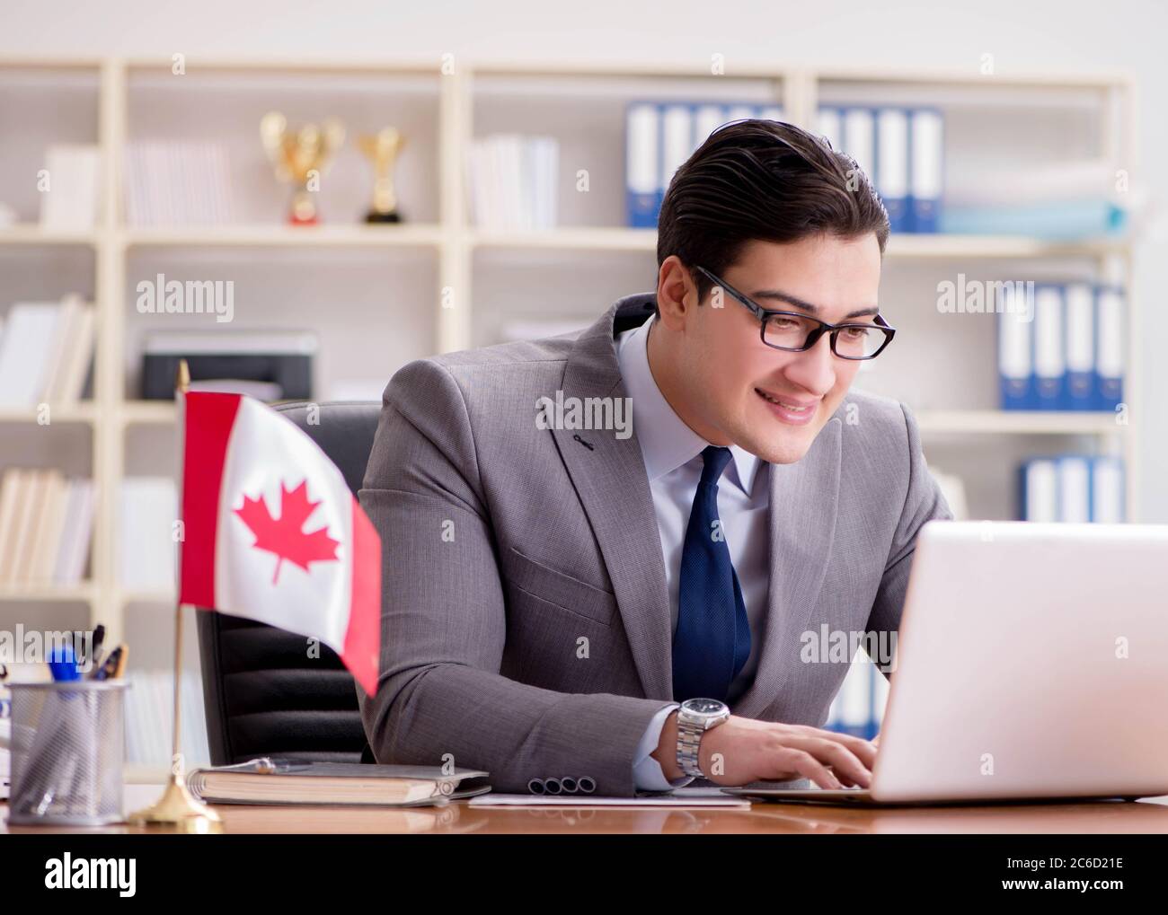 The businessman with canadian flag in office Stock Photo - Alamy