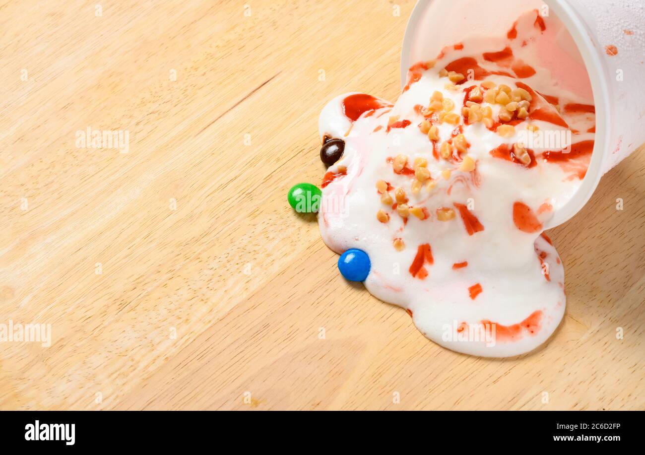 cup of fresh strawberry and vanilla flavor ice cream sundae melting ...