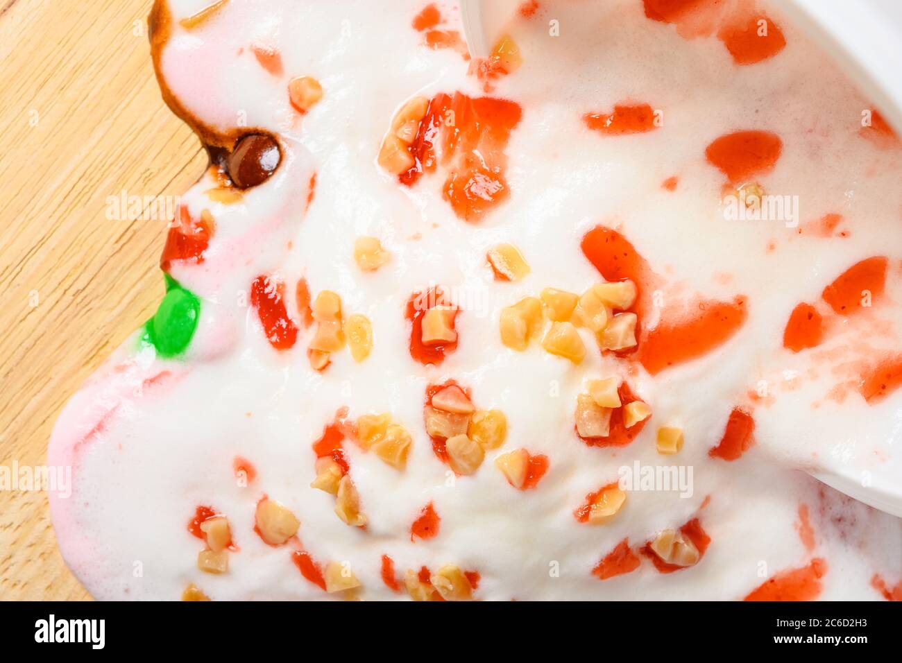 melted cup of fresh strawberry and vanilla flavor ice cream sundae ...