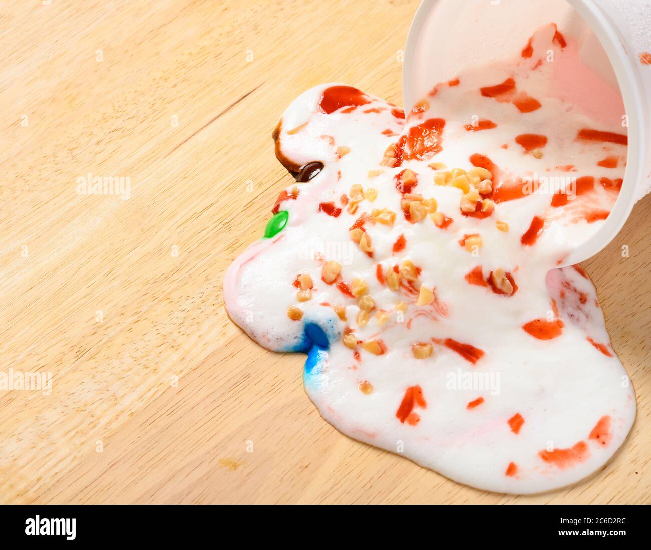 melted cup of fresh strawberry and vanilla flavor ice cream sundae ...