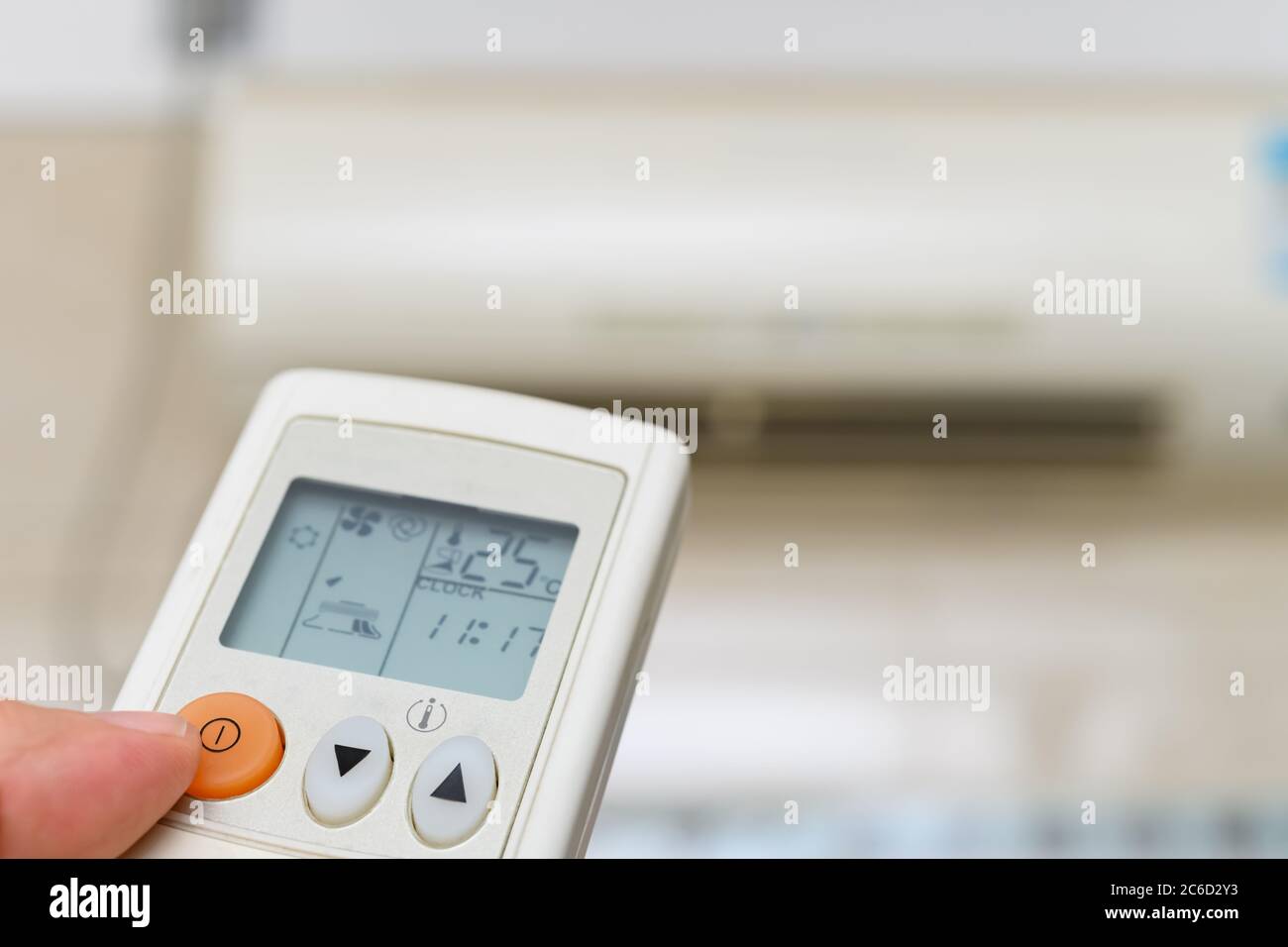 turning on an air conditioner via a remote control Stock Photo - Alamy
