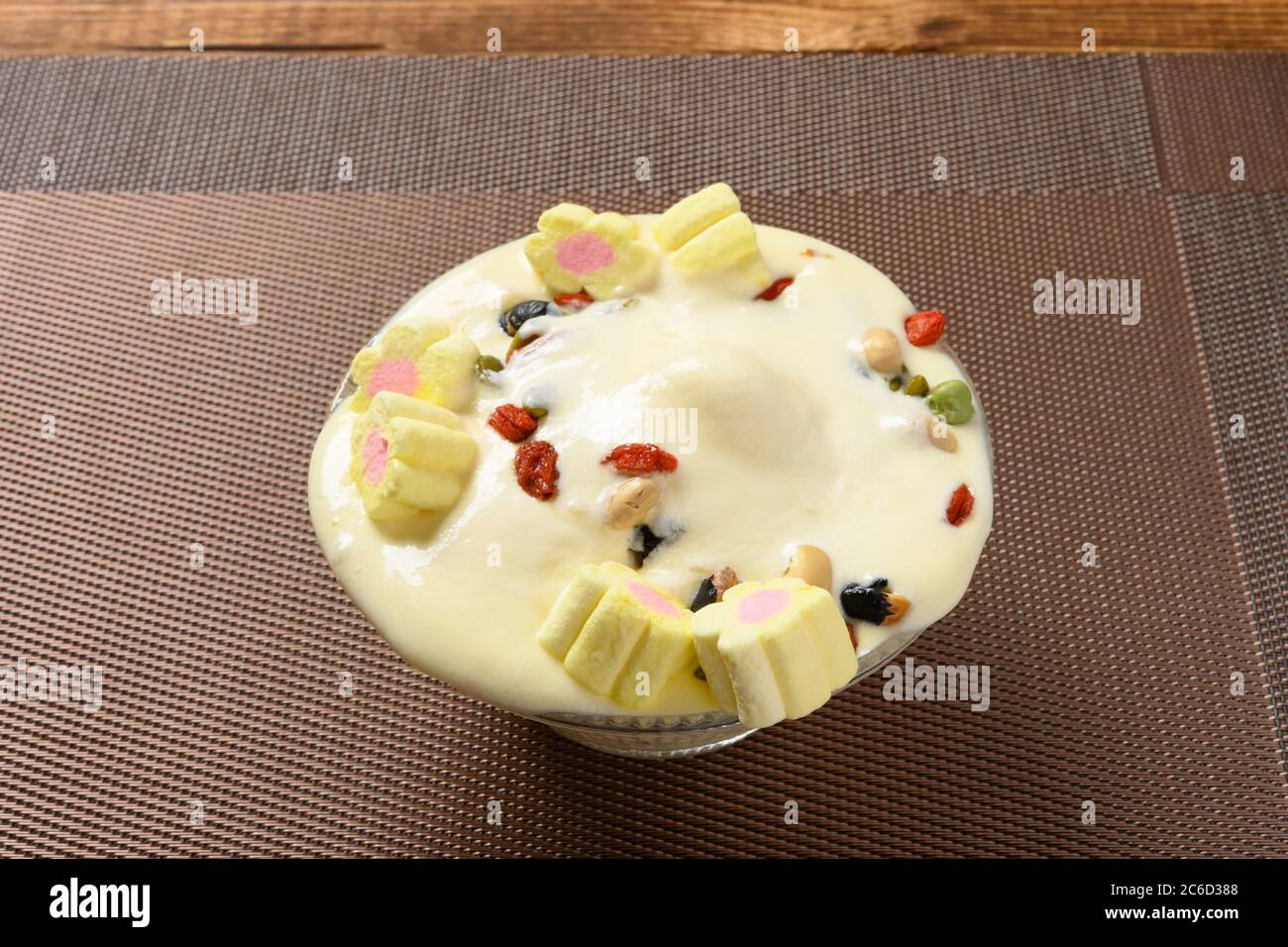 melted bowl of vanilla flavor ice cream sundae in a melting process ...