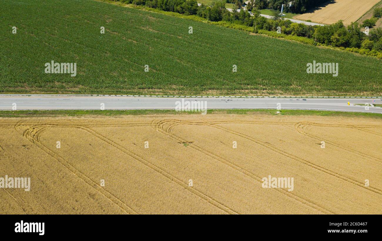 Aerial view of a country road in beautiful agricultural fields in ...