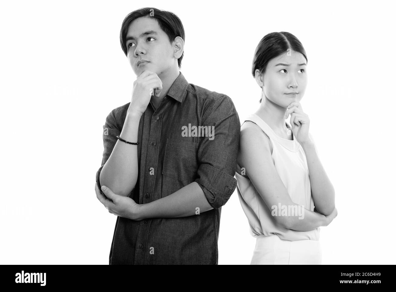 Studio shot of young Asian couple thinking together Stock Photo - Alamy