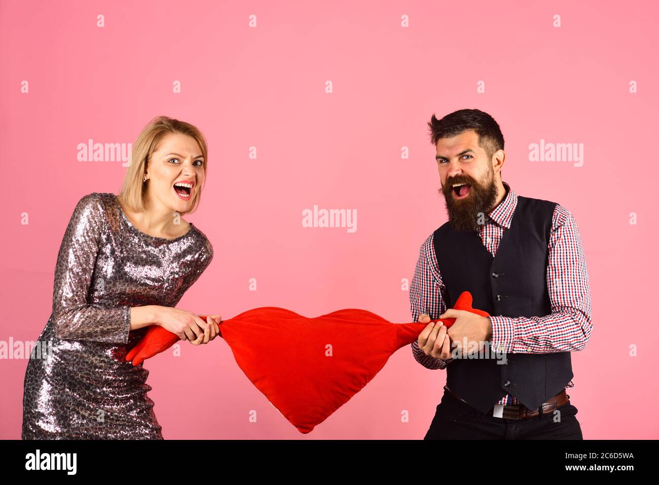 Couple in love tears big heart on pink background. Boyfriend and ...